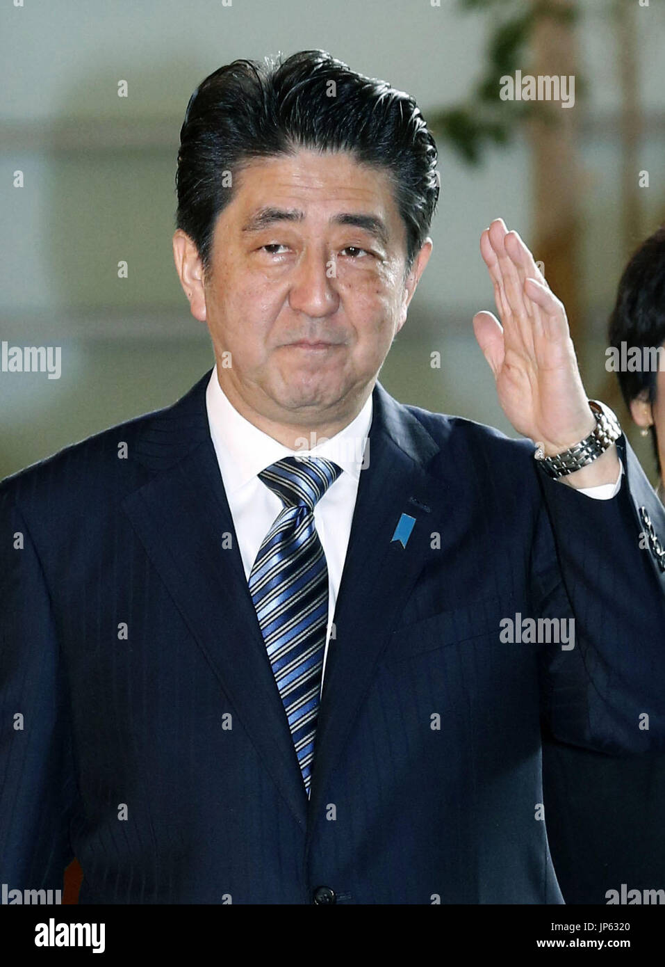 TOKYO, Japan - Prime Minister Shinzo Abe waves as he enters his office ...