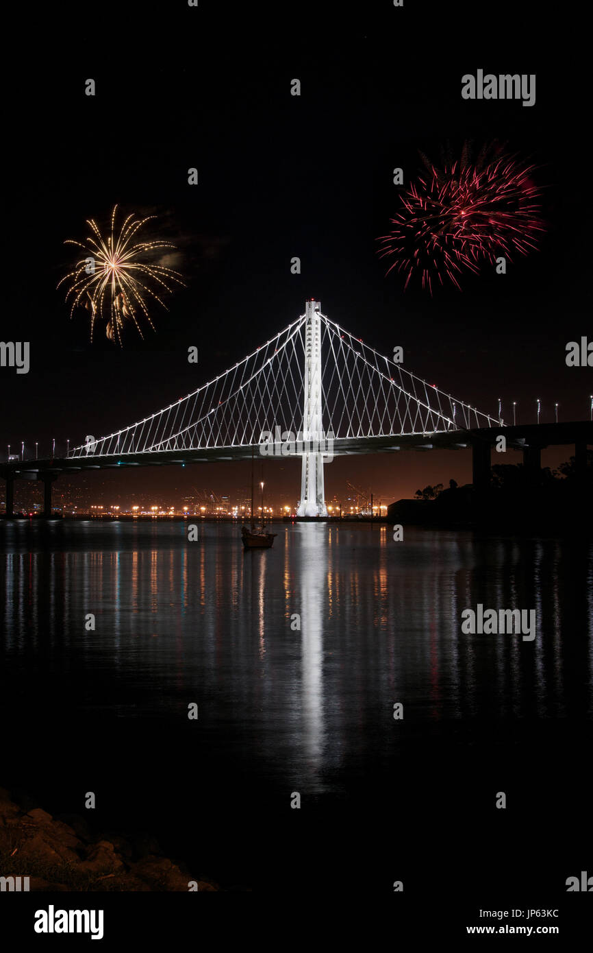New East Span Bay Bridge illuminated at night, reflecting color lights ...