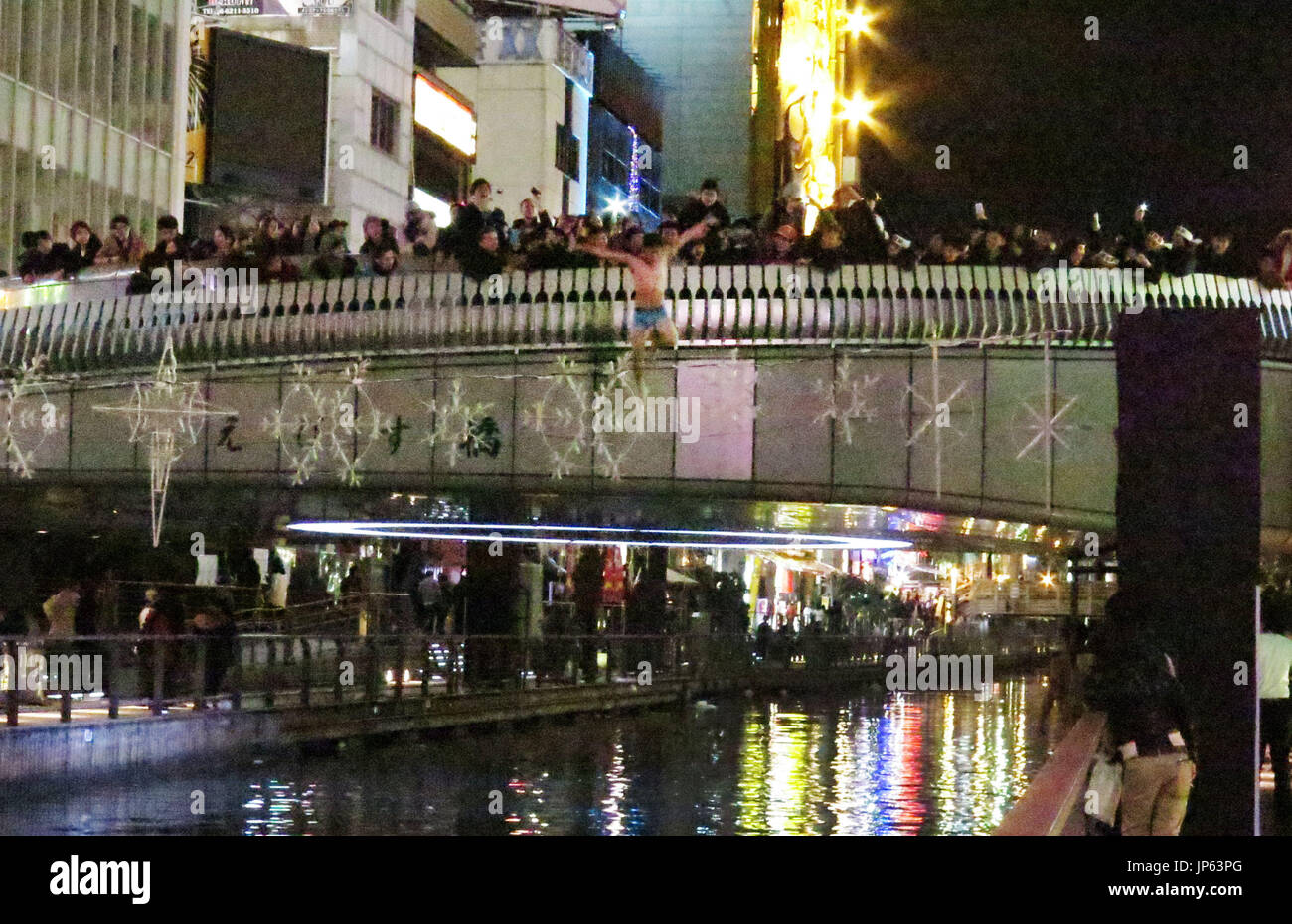 OSAKA, Japan - A man dives into the Dotombori River in central Osaka in ...