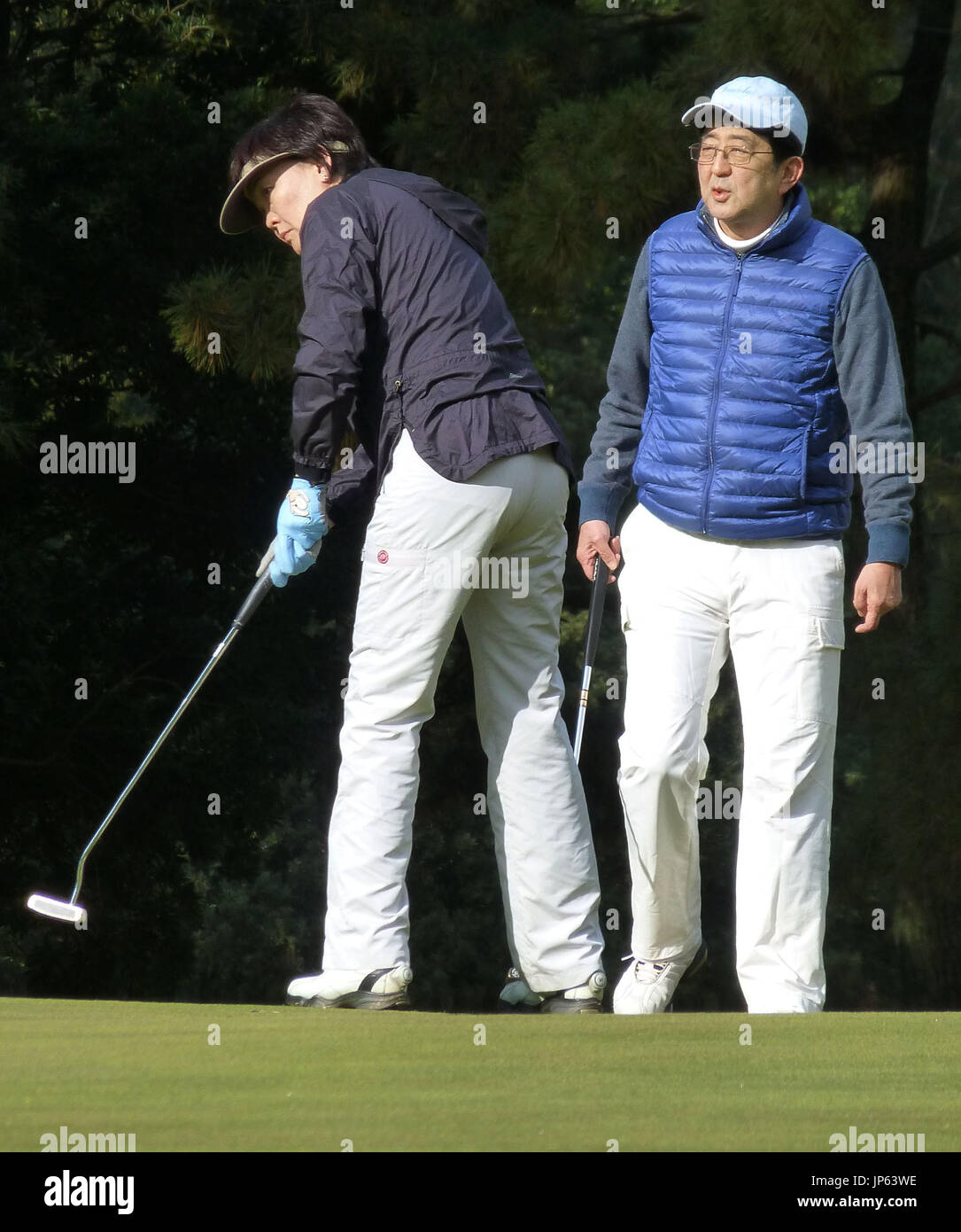CHIGASAKI, Japan - Prime Minister Shinzo Abe (R) plays golf with his ...