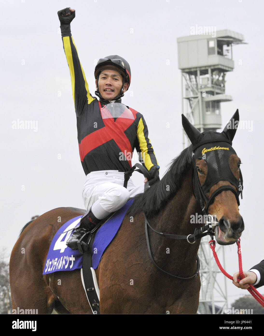 FUNABASHI, Japan - Jockey Keita Tosaki celebrates Gentildonna's victory ...
