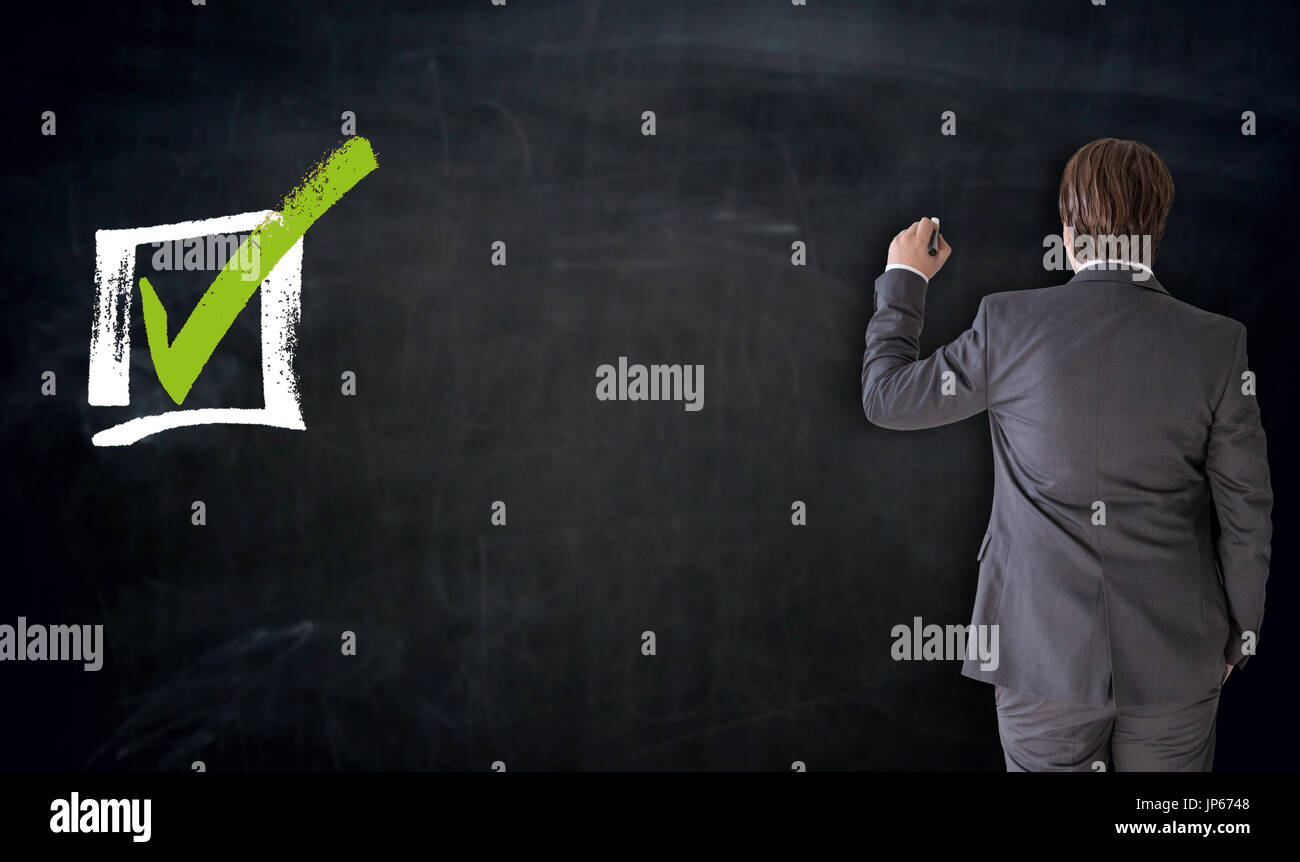 Businessman writing with checkbox concept on blackboard Stock Photo - Alamy
