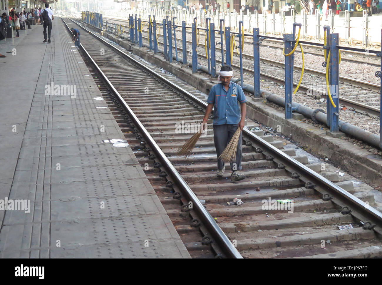 Indian Railroad workers cleaning rail tracks in India, Asia Stock Photo ...