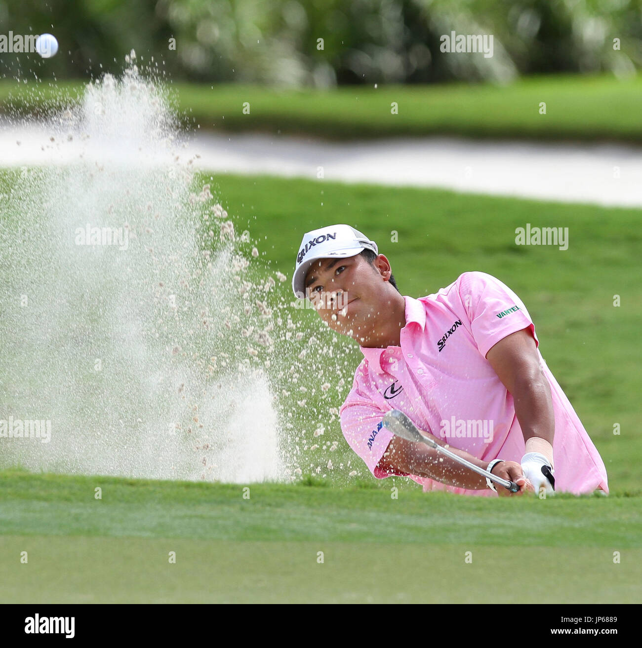 Japanese golfer Hideki Matsuyama hits a bunker shot on the 12th hole ...