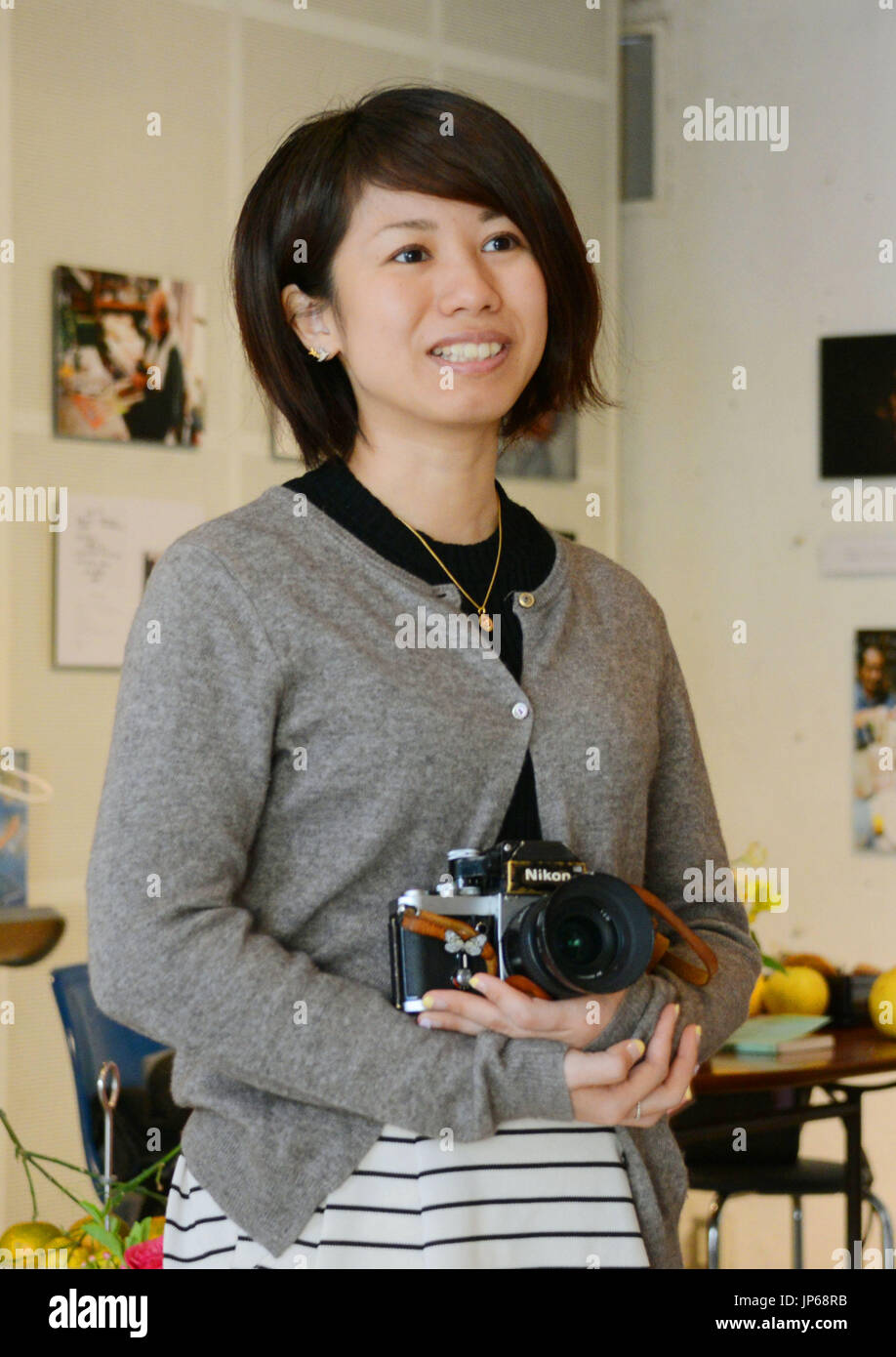 Naoko Tokumoto poses at her photo exhibition, financed by donations ...