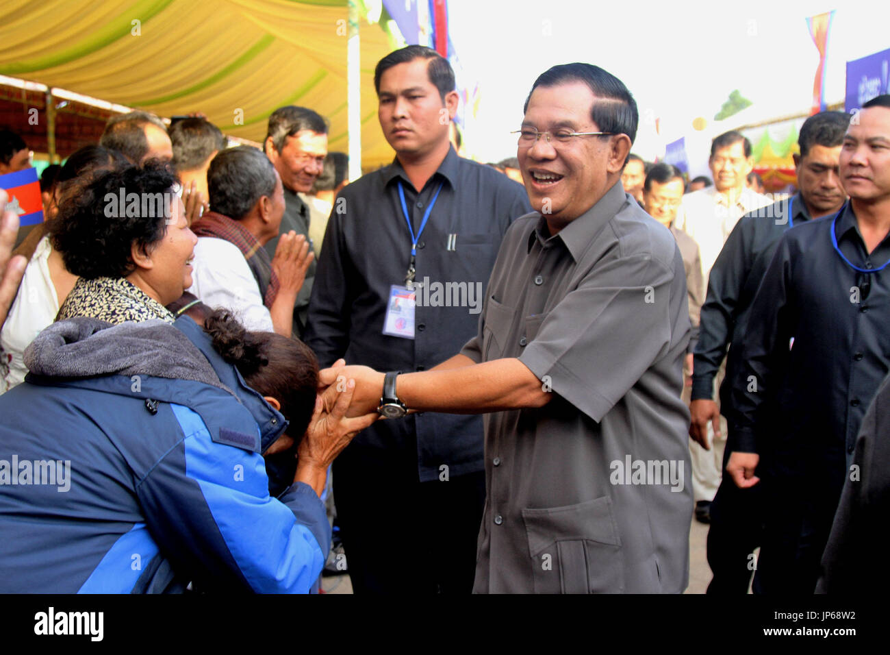 Cambodian Prime Minister Hun Sen shakes hands with supporters during an ...
