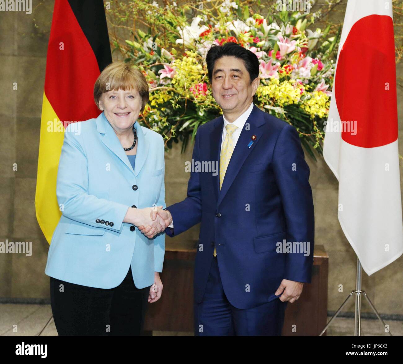 German Chancellor Angela Merkel (L) shakes hands with Japanese Prime ...
