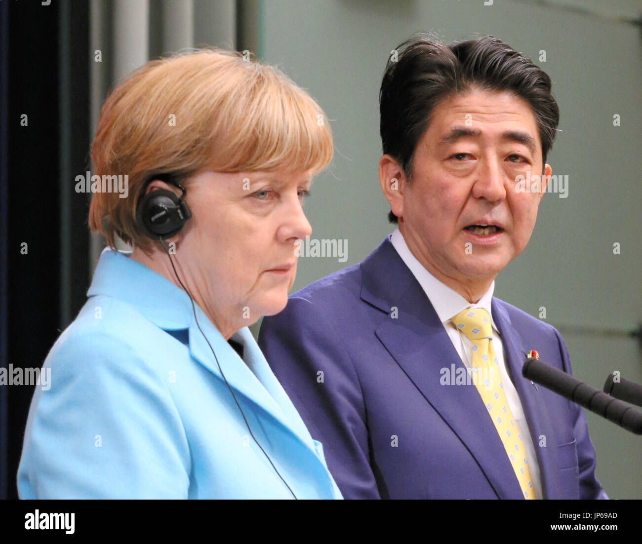 File photo shows Japanese Prime Minister Shinzo Abe (R) and German ...
