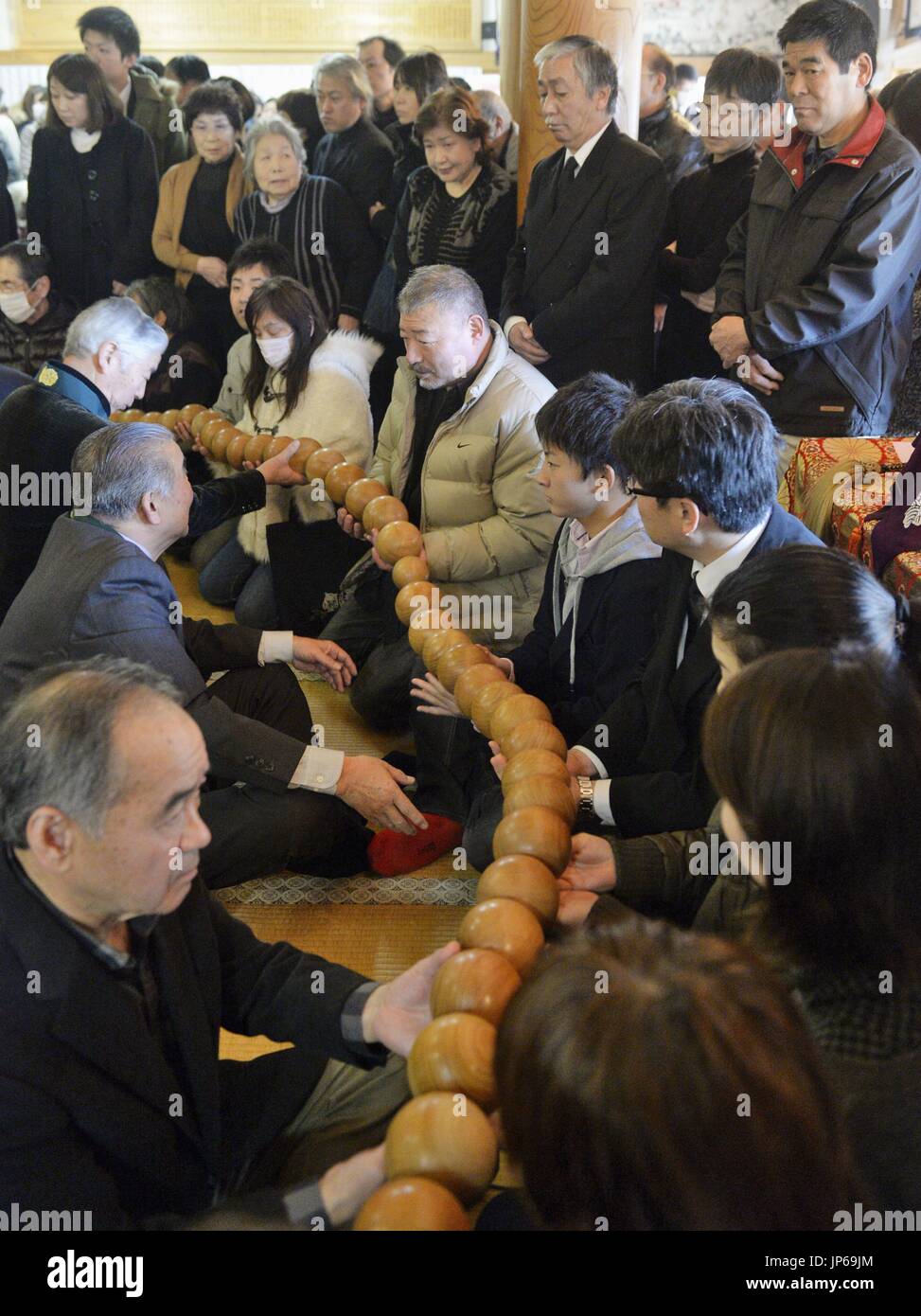 People at a temple in the northeastern Japan city of Higashimatsushima ...
