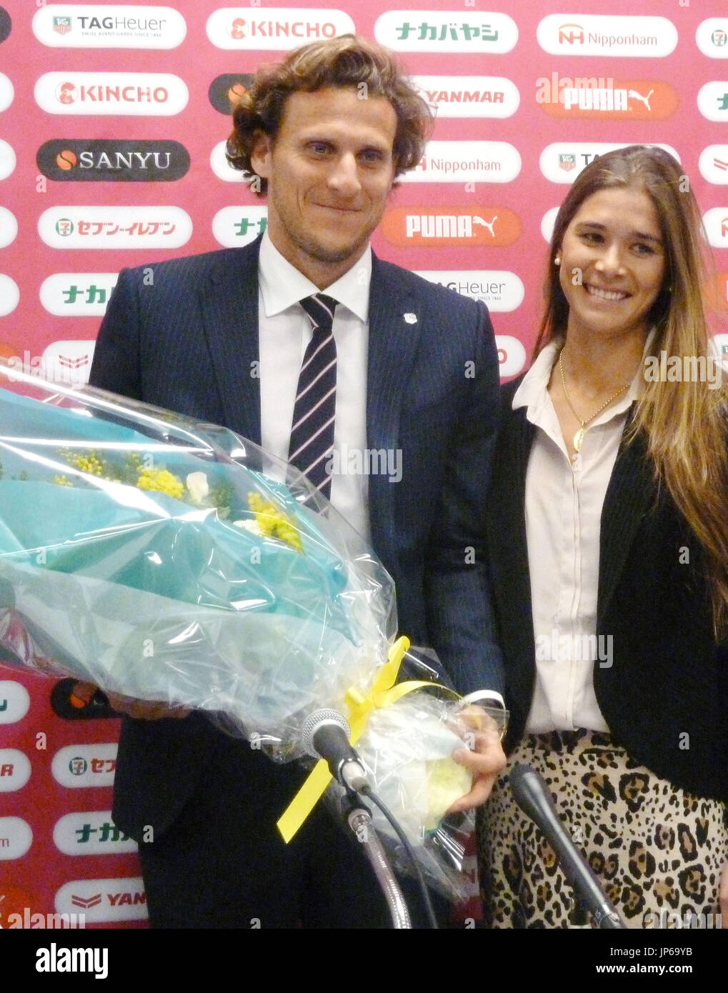Uruguay striker Diego Forlan receives flowers, alongside his wife Paz ...