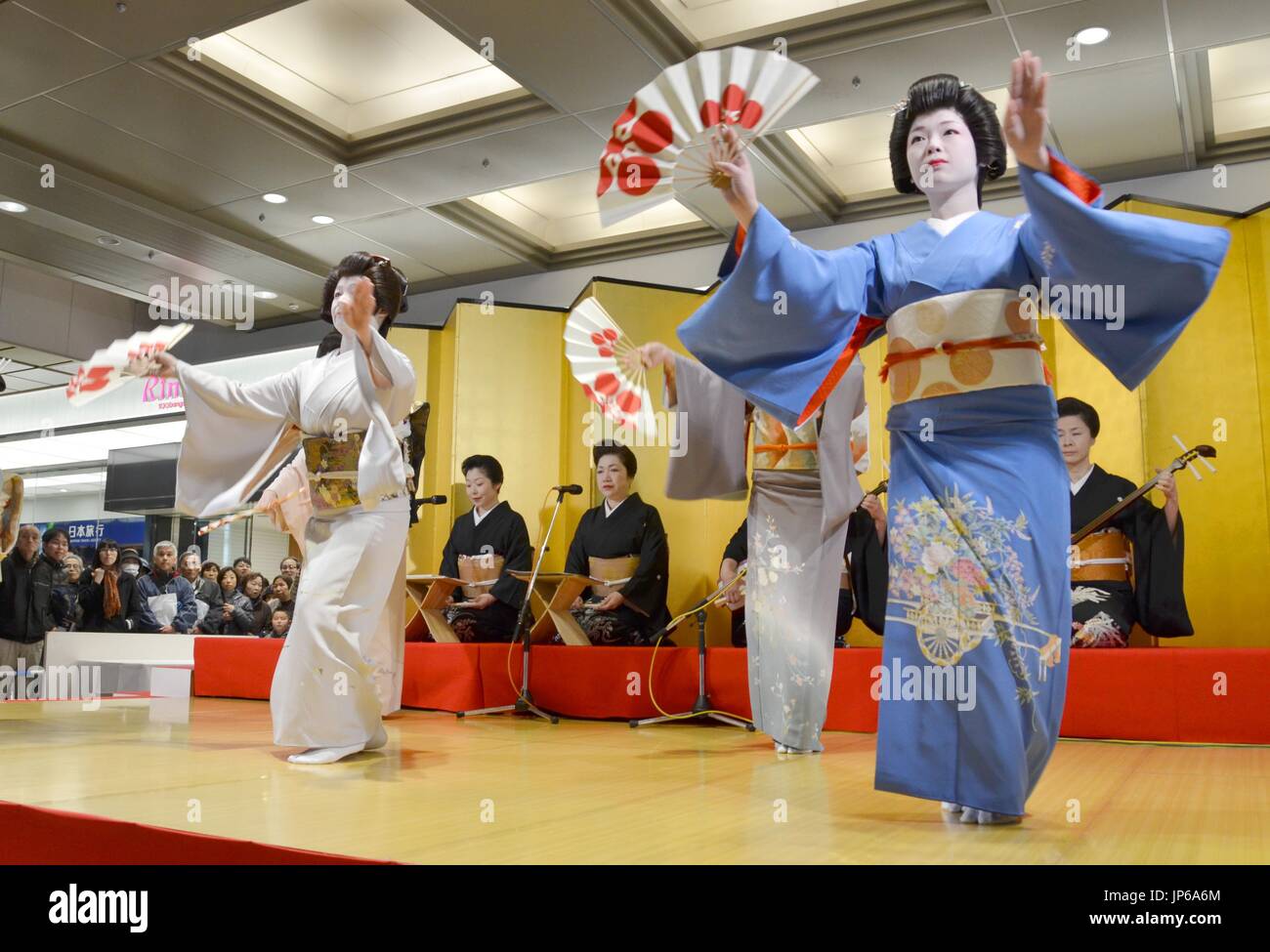 Geisha dance on a special stage set up in front of the gate of the ...
