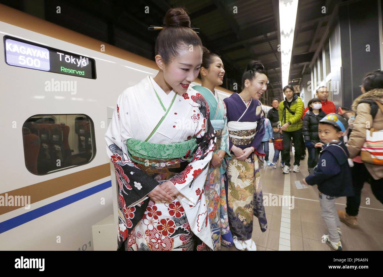Women in kimono greet departing passengers on the platform at JR ...
