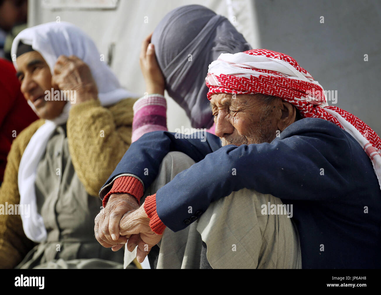 A Syrian man looks exhausted at a refugee camp in Suruc in southern ...