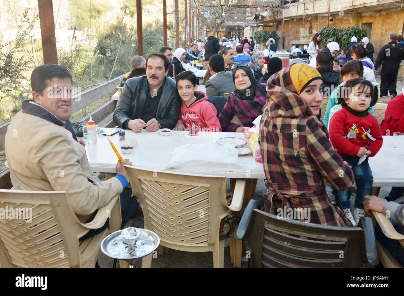 Syrian citizens enjoy meals at a picnic facility in Damascus on March 6 ...