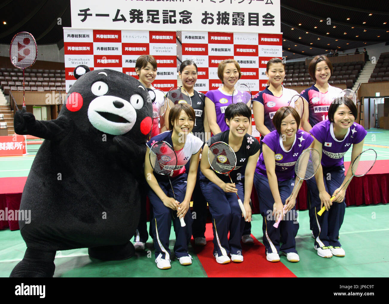 Members of Saishunkan Co.'s badminton team pose for a photo with ...