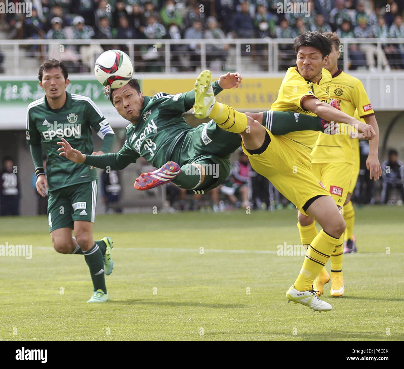 Defender Takumi Abe of Yamamoto Yamaga (2nd from L) and midfielder ...