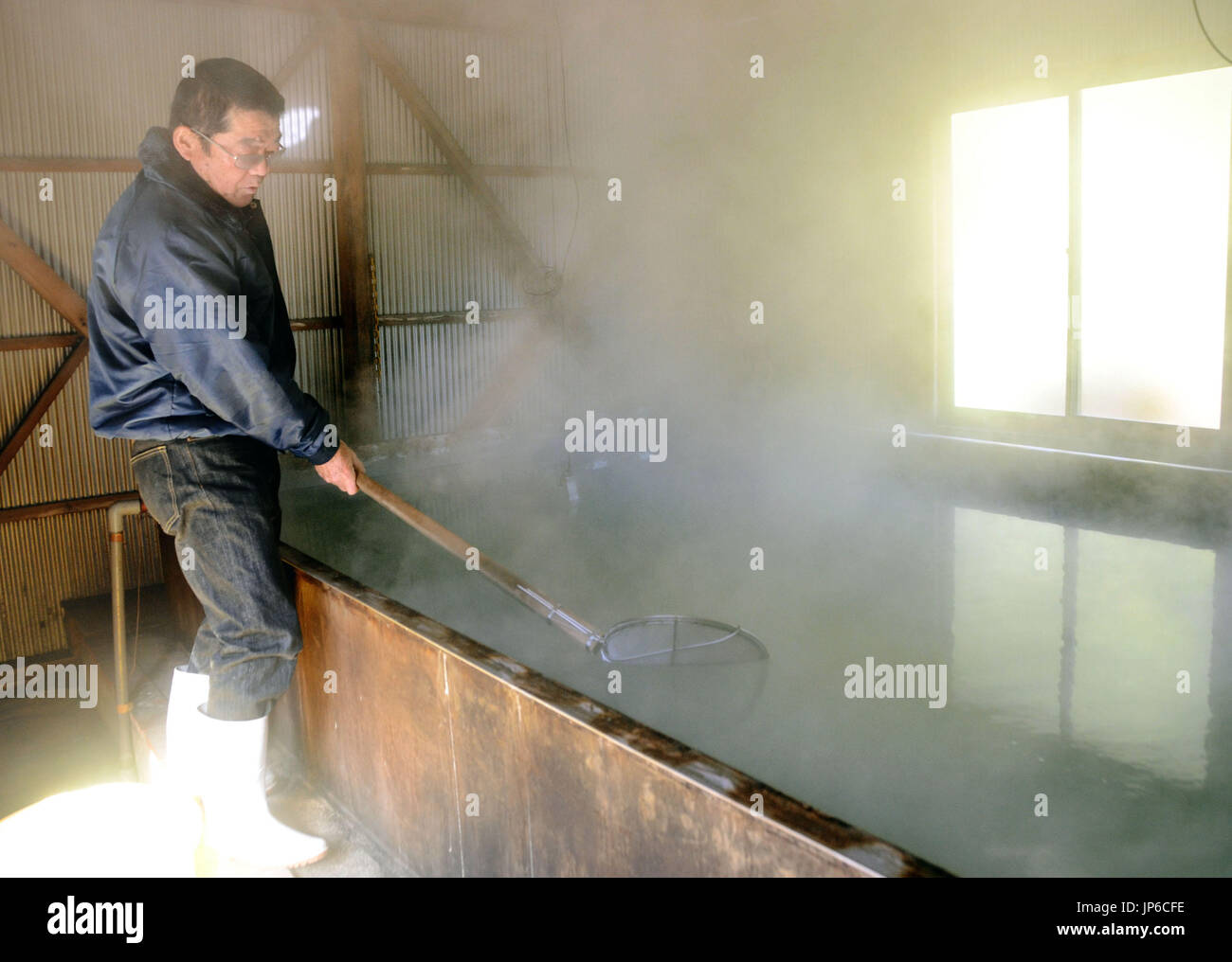 Mitsutaka Matsuura, a 65-year-old former Osaka resident, watches ...