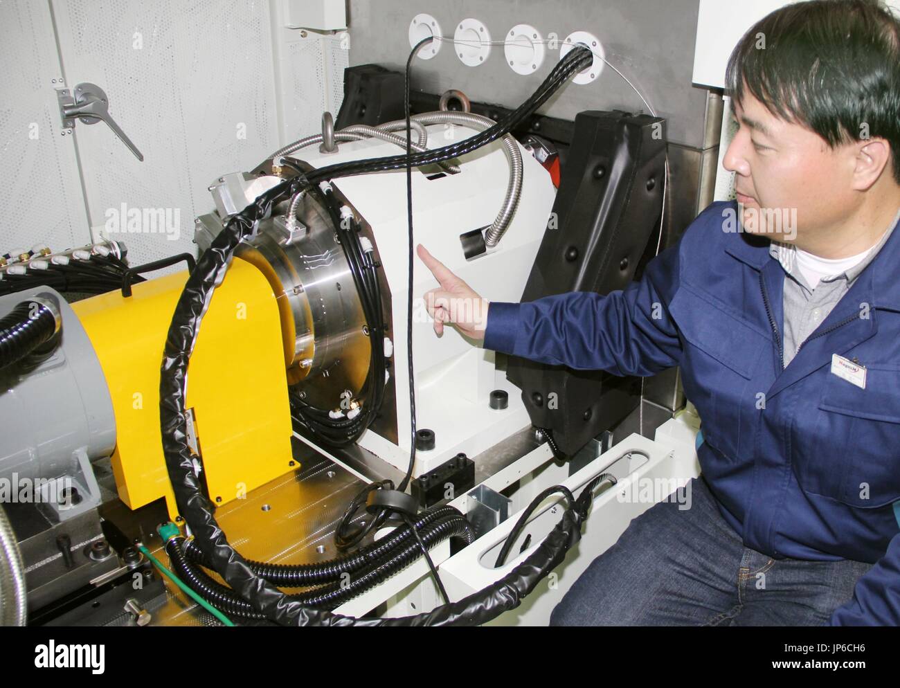 A researcher explains a high-precision motor analyzer developed by the ...