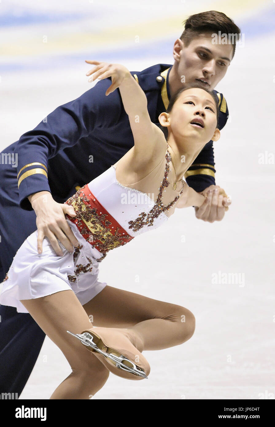 Ami Koga (R) and Francis Boudreau Audet, representing Japan, perform in ...