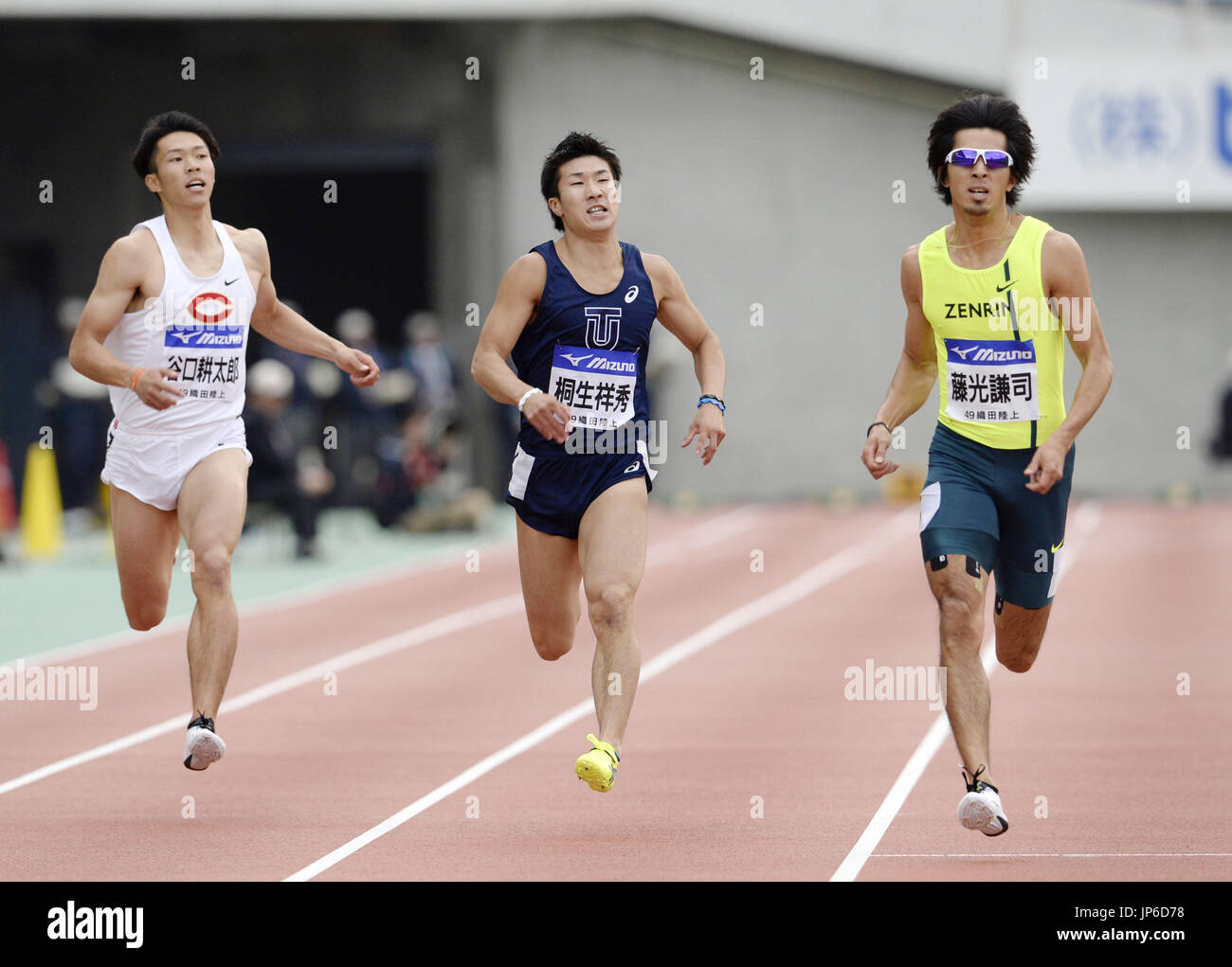 Japanese sprinter Yoshihide Kiryu (C) comes in third in the men's 200 ...