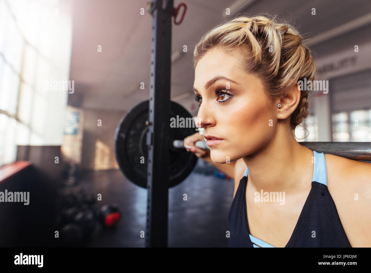 Closeup of a female athlete lifting weight bar at the gym. Woman ...
