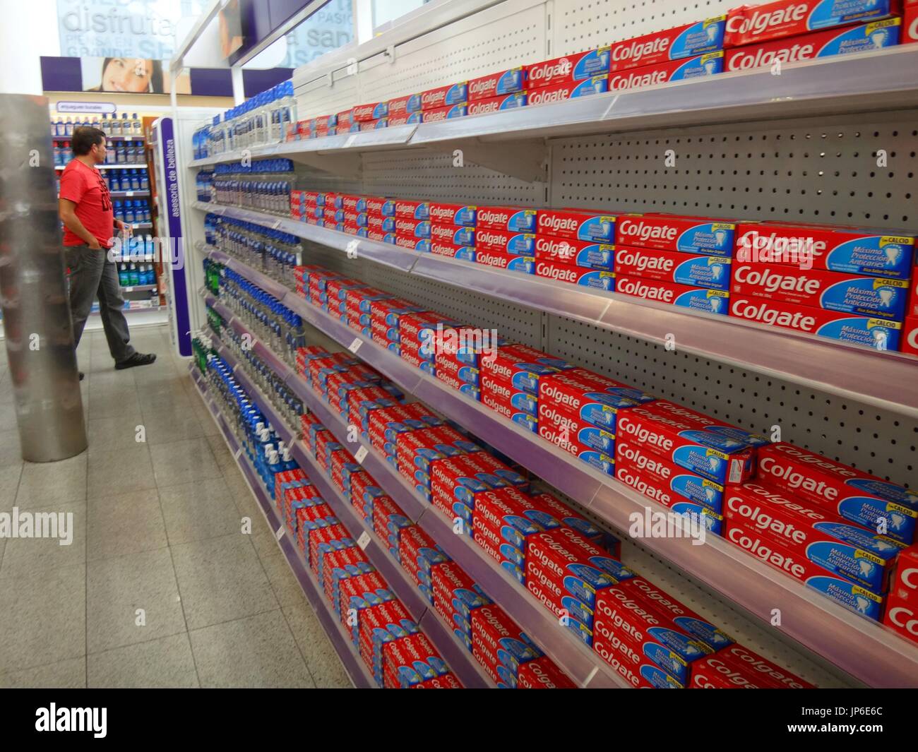 Toothpaste of the same brand occupies shelves at a drugstore in Caracas ...