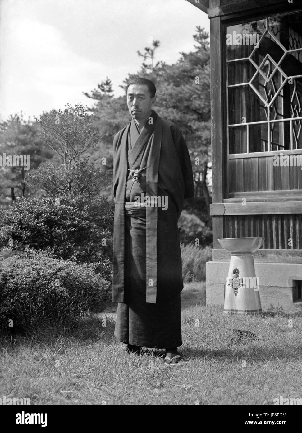 Fumimaro Konoe, a former prime minister of Japan, stands in the garden ...