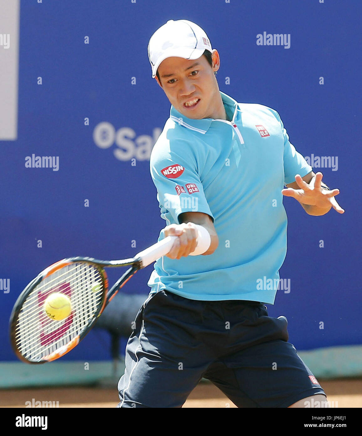 Kei Nishikori of Japan returns the ball against Roberto Bautista Agut ...