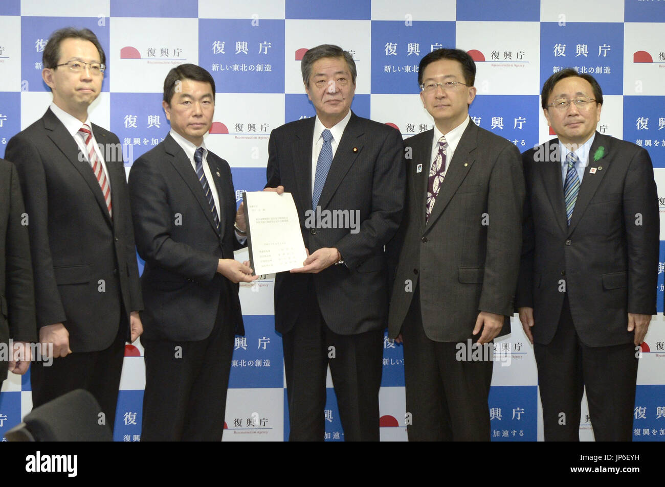 Reconstruction Minister Wataru Takeshita (C) receives a letter of ...