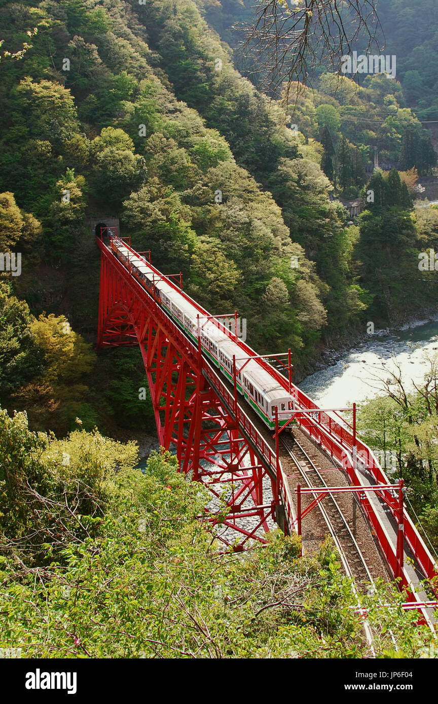 A train runs across a bridge over Kurobe Gorge in Kurobe, Toyama ...