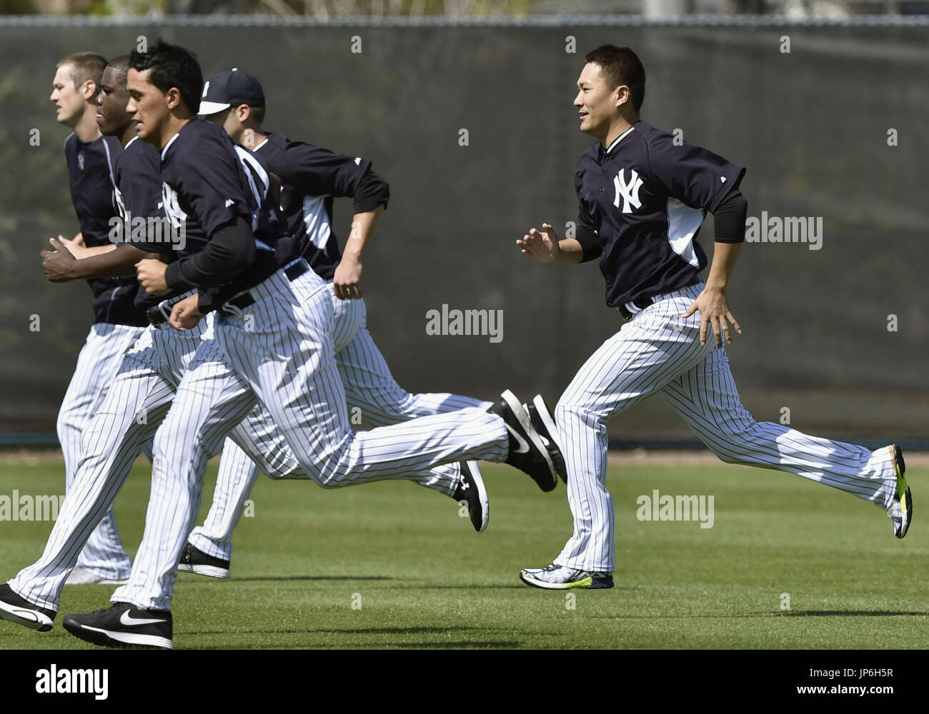 New York Yankees pitcher Masahiro Tanaka of Japan (R) runs with ...