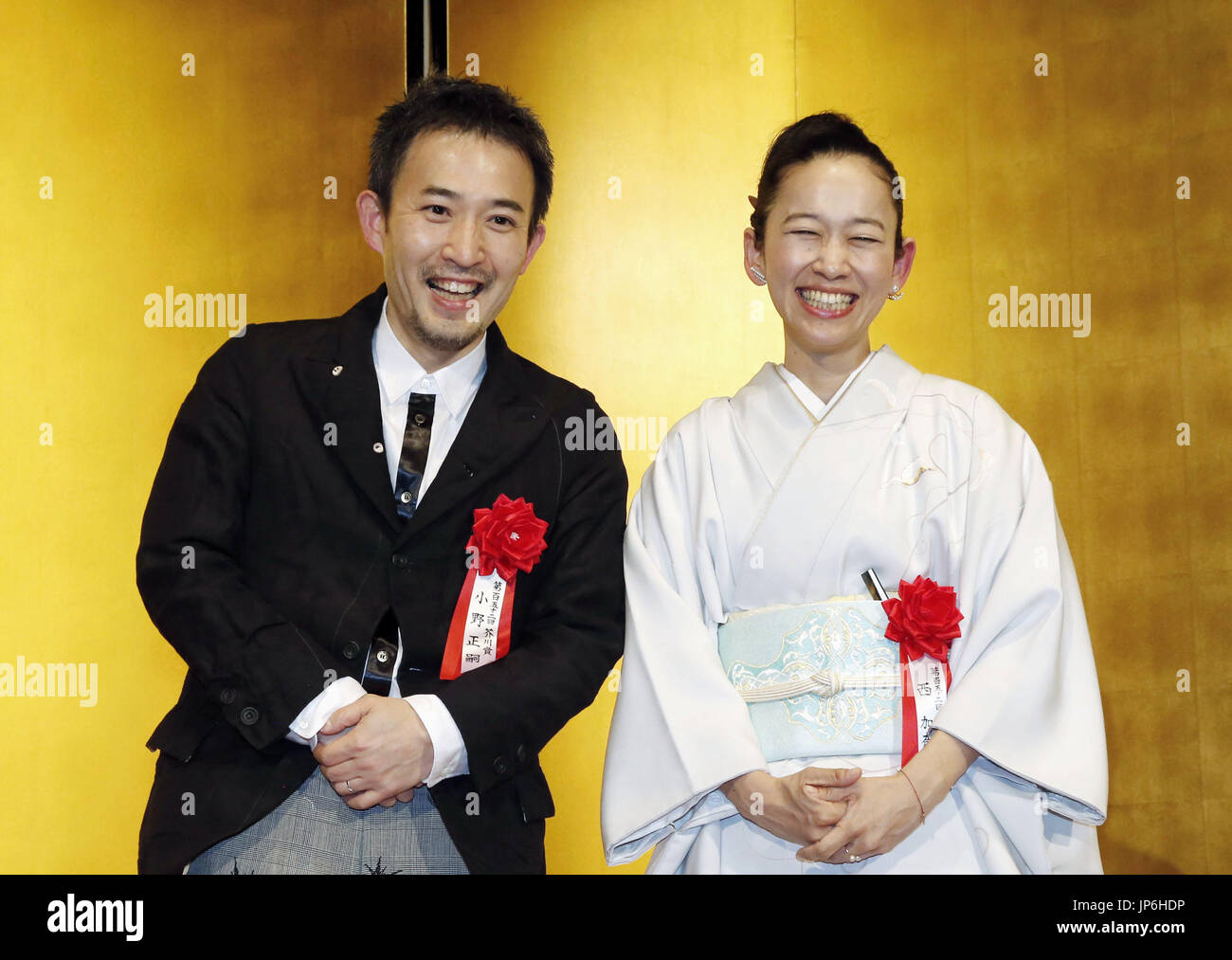 Novelists Masatsugu Ono (L) and Kanako Nishi pose for a photo during an award ceremony in Tokyo ...