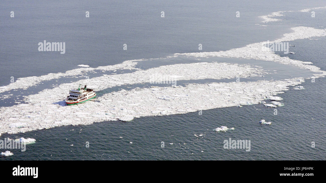 An ice-breaker carrying tourists plows through drift ice on the Sea of ...
