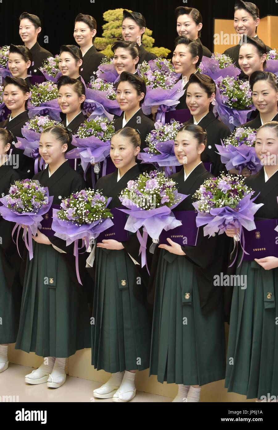 Graduates pose for group photos after a graduation ceremony March 2 ...