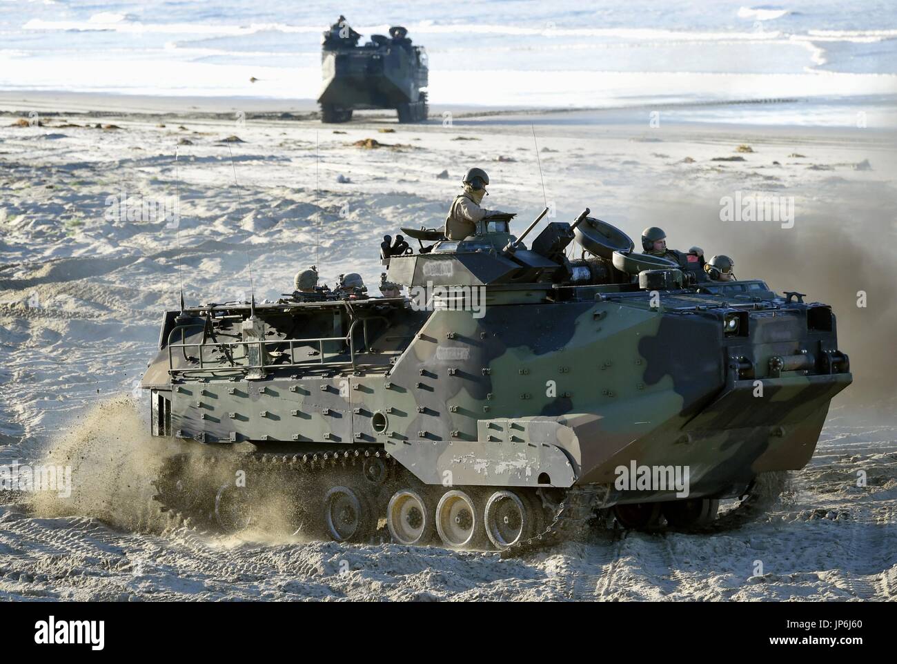 An AAV-7 amphibious vehicle makes its way across a sandy beach during a ...