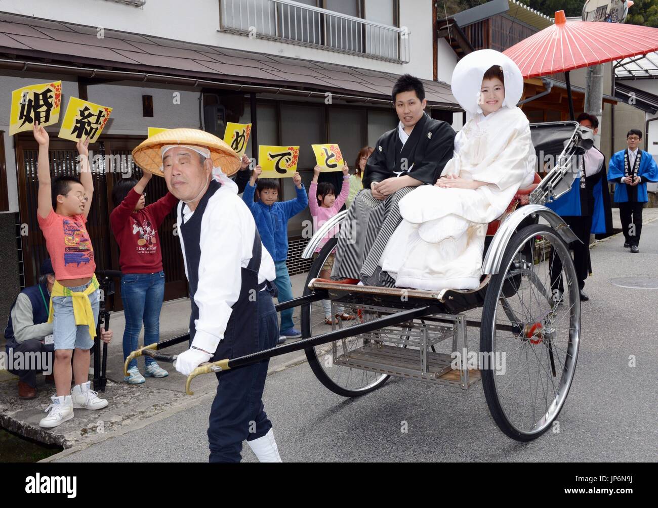 Bride Erika Hara (R) and groom Koichi Hirokawa aboard a rickshaw ...