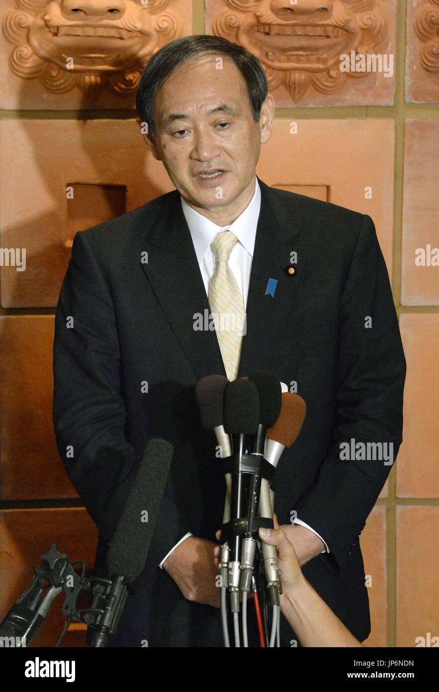 Chief Cabinet Secretary Yoshihide Suga speaks to reporters at a hotel ...