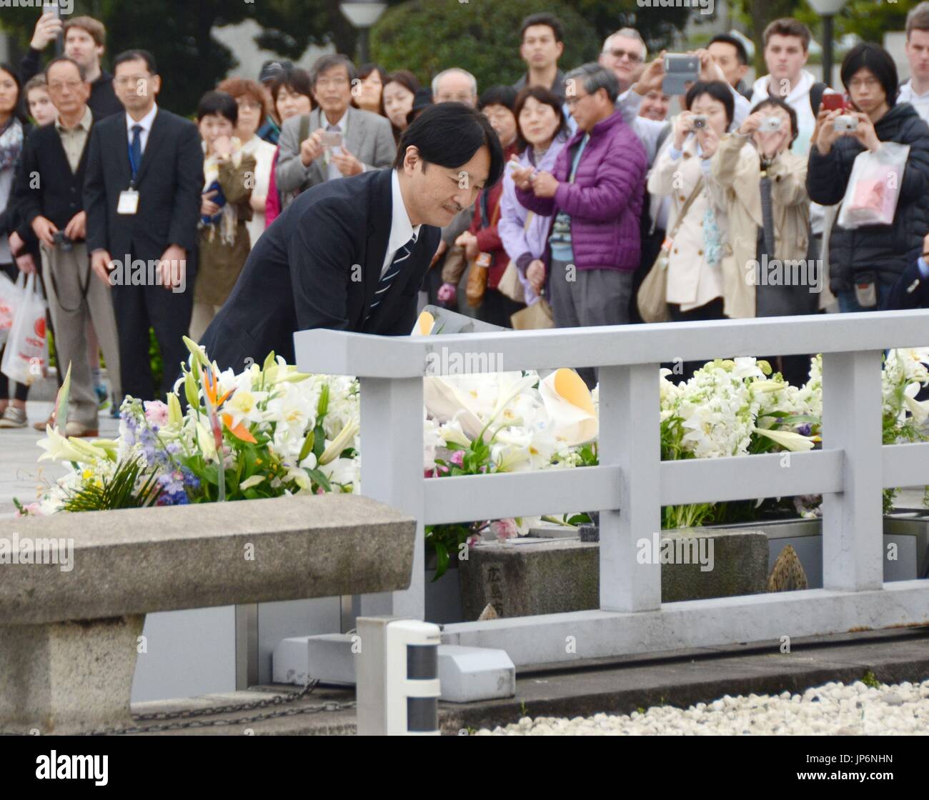 Japanese Prince Akishino places flowers at the cenotaph for atomic bomb ...