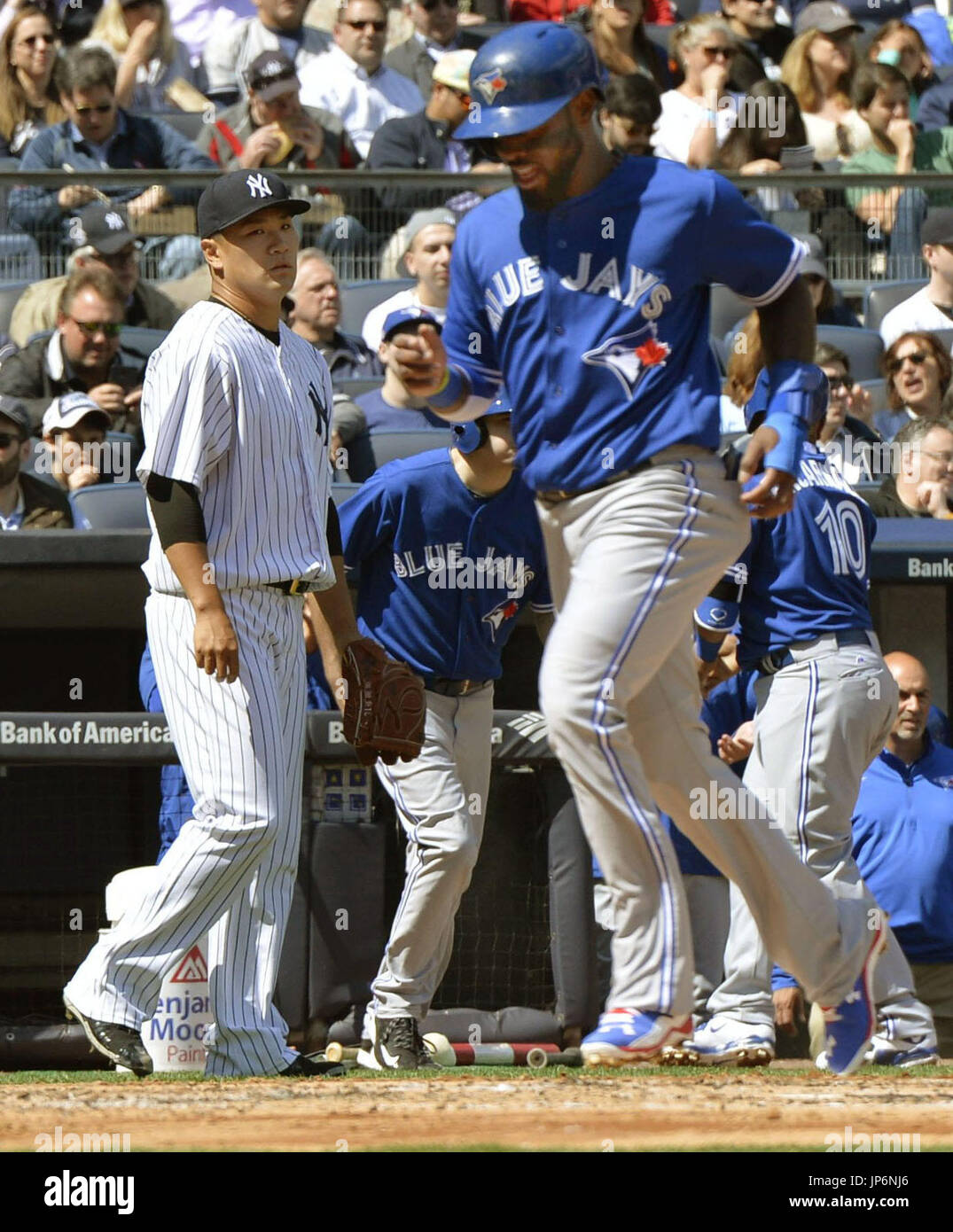 New York Yankees starter Masahiro Tanaka (L) watches a runner returning ...