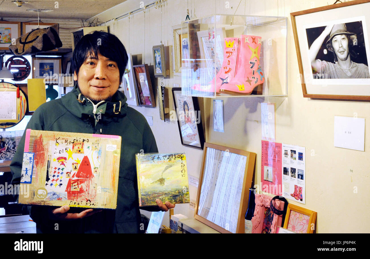 A fan of the late rock singer Kiyoshiro Imawano poses on April 7, 2015 ...