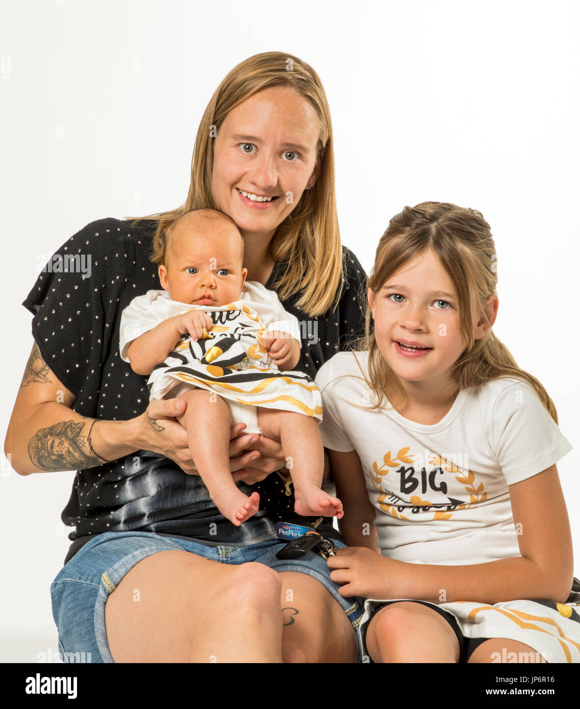 Studio portrait of mother, 7 year old daughter & 7 week old baby Stock ... Studio portrait of mother, 7 year old daughter & 7 week old baby Stock ...