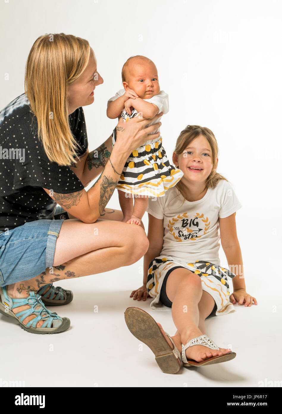 Studio portrait of mother, 7 year old daughter & 7 week old baby Stock ... Studio portrait of mother, 7 year old daughter & 7 week old baby Stock ...