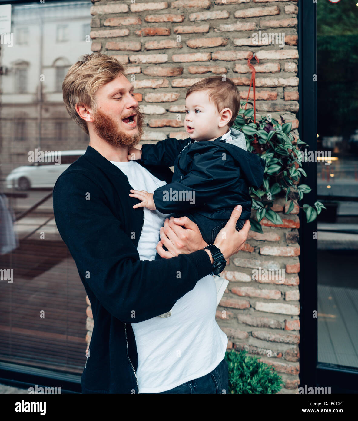 Dad with a small son in his arms Stock Photo - Alamy