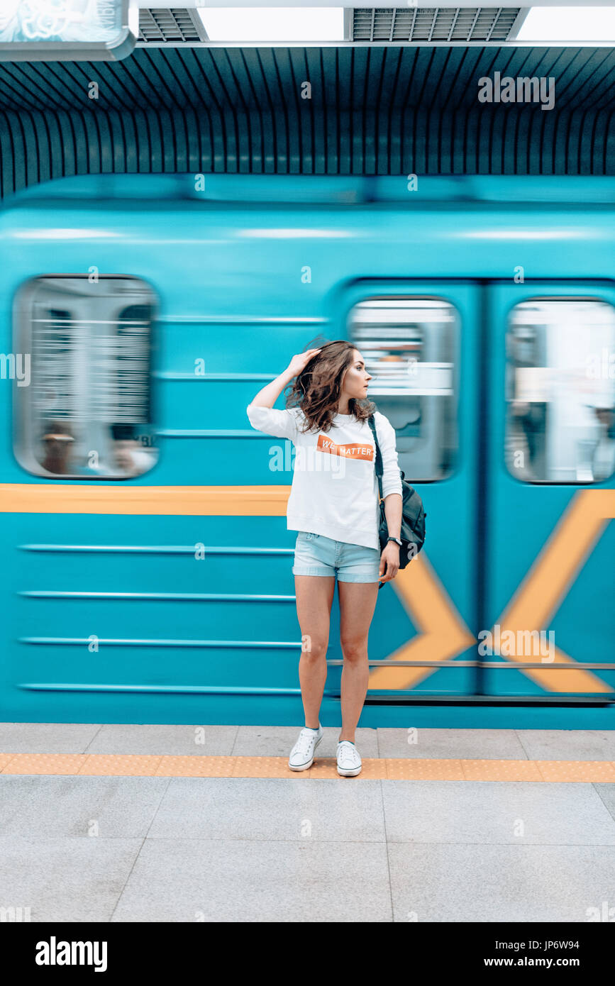 Beautiful young girl posing on metro station Stock Photo - Alamy