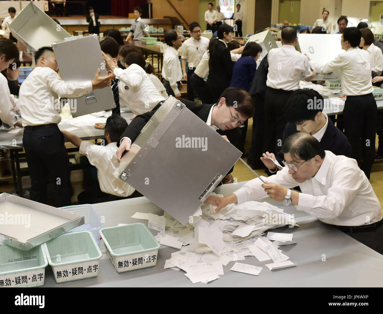 Election officials open ballot boxes to count votes for a referendum on ...