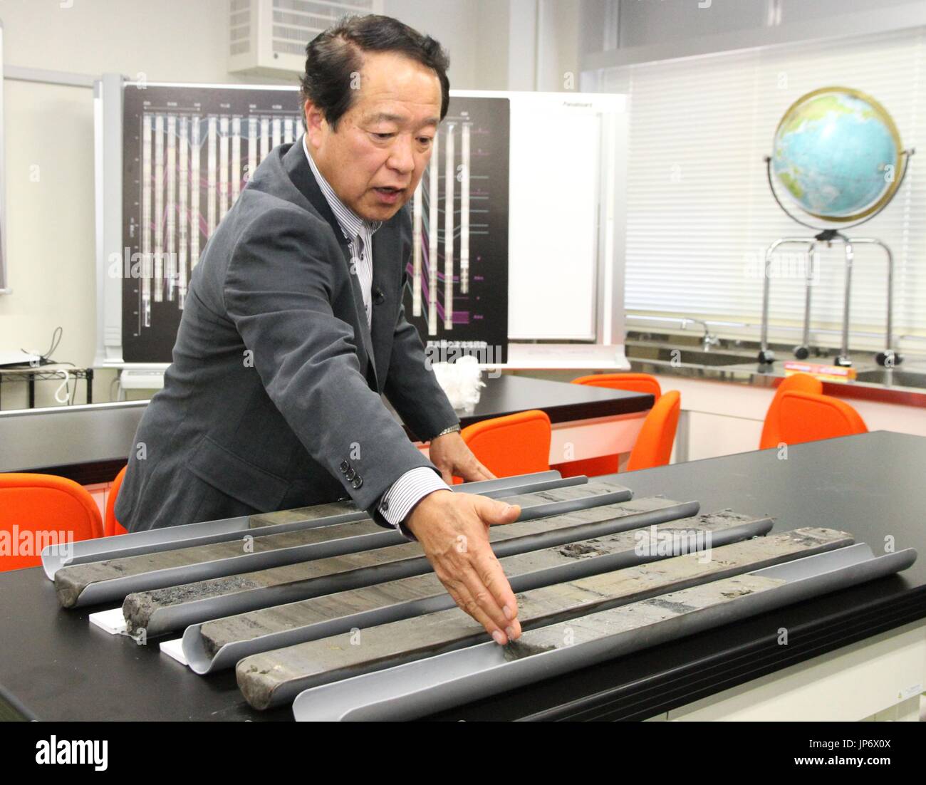 Professor Makoto Okamura of Kochi University points to samples of ...