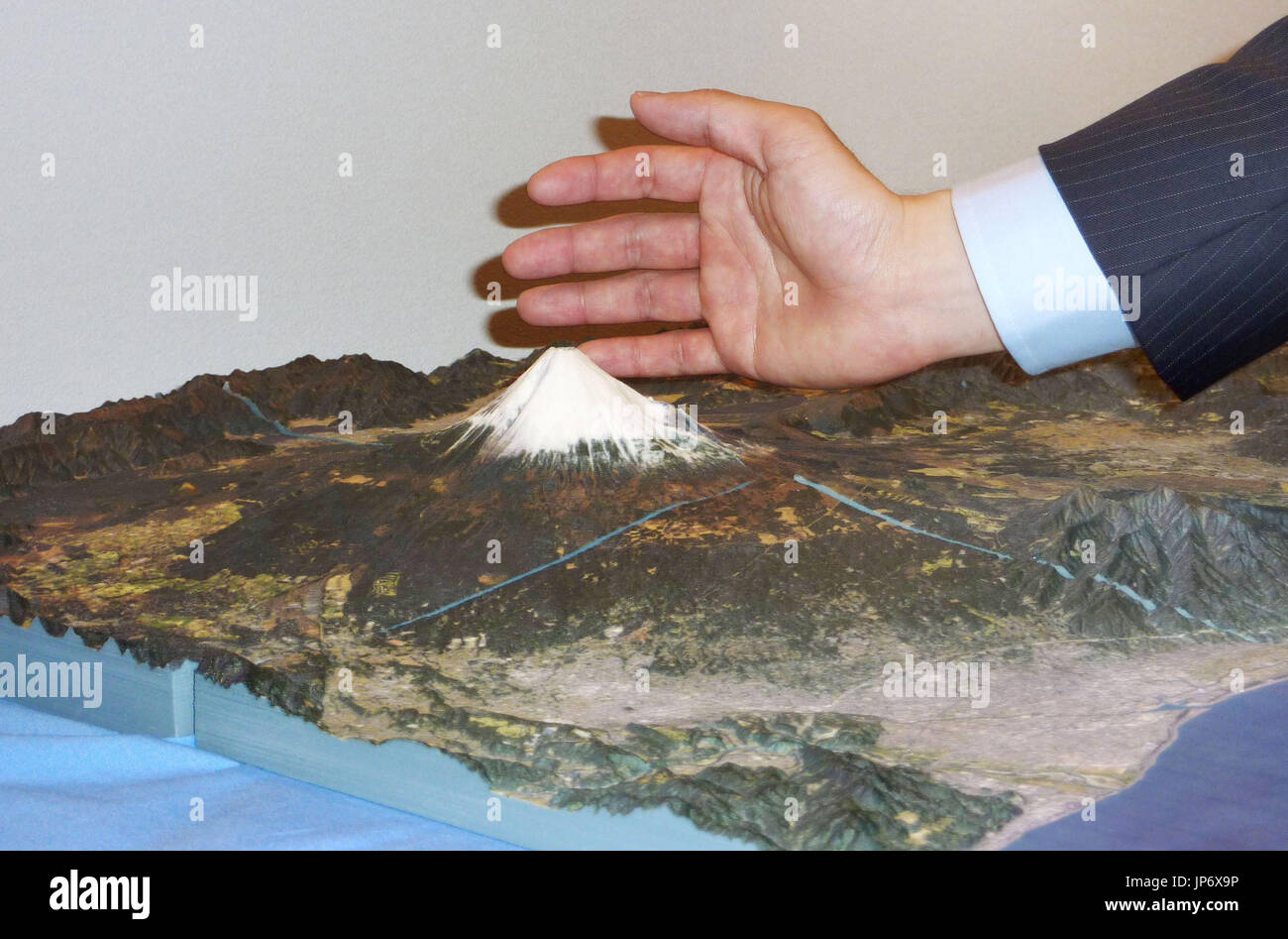 NTT Data Corp. shows a scale model of Mt. Fuji on May 18, 2015, made by ...