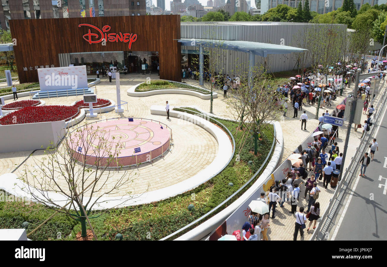 People wait in line to enter a new Disney Store in Shanghai on its ...