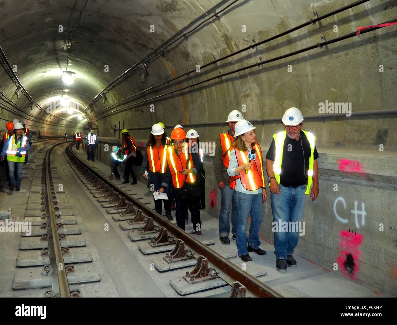 Workers walk along a subway line being built under Manhattan's Second ...