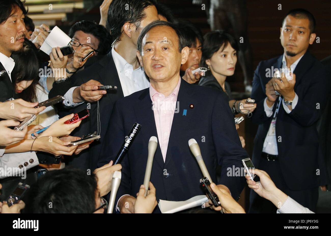 Japanese Chief Cabinet Secretary Yoshihide Suga speaks to reporters at ...